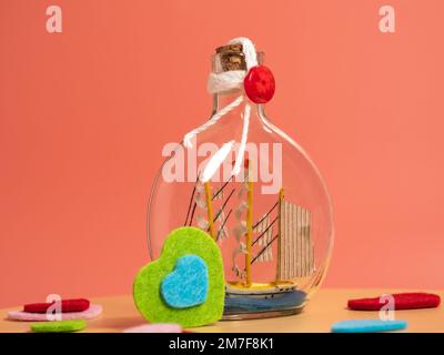 Ship in a bottle and hearts on a pink background. Close-up Stock Photo ...