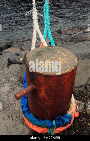 A Bollard and ships ropes in the harbour of the Cornish fishing port of ...