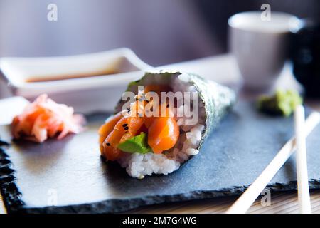 Salmon temaki. Temakis are cone-shaped pieces of sushi made of nori ...