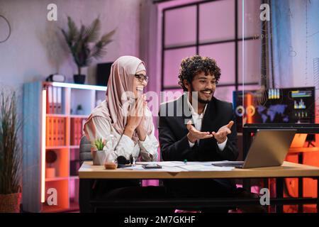 Overjoyed multiracial business people, muslim businesswoman and male ...