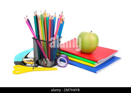Green apple with notebooks, pencils holder, school stationery and clock ...