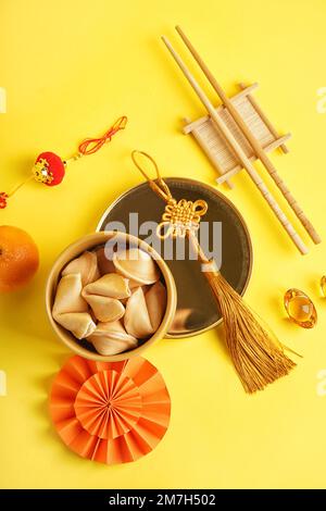 Fortune cookies, mandarin and Chinese symbols on yellow background. New ...