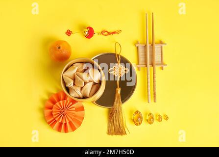 Fortune cookies, mandarin and Chinese symbols on yellow background. New ...