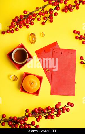 Red envelopes with tea and Chinese symbols on color background. New ...