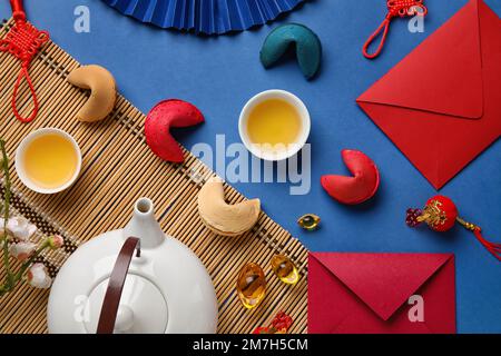 Teapot, cups of tea, envelopes and Chinese symbols on red background ...