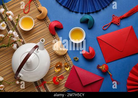 Teapot, cups of tea, envelopes and Chinese symbols on red background ...