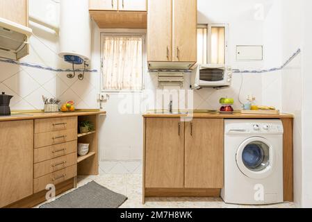 Conventional Wood Kitchen Cabinets with Built-in Appliances and Window ...