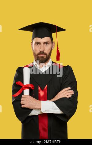 Front view of man with beard graduating from university, college ...