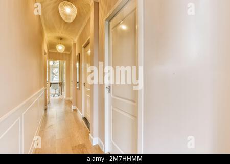 A well-lit hallway in a white interior house setting Stock Photo - Alamy