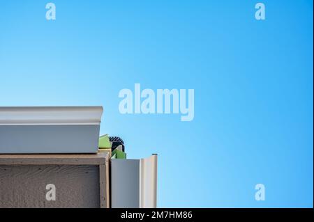 Metal gutters be installed on a residential buildings with two sections ...