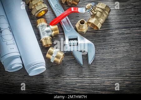 Adjustable wrench plumbing pipe fittings rolled blueprints Stock Photo ...