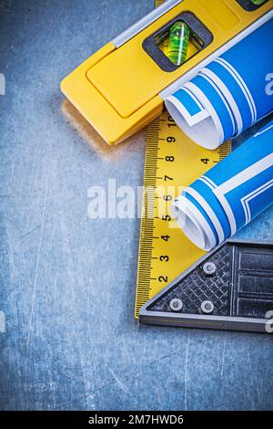 Blue blueprints construction level square ruler on metallic background ...