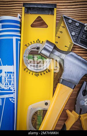 Gripping tongs on vintage wooden board directly above construction ...