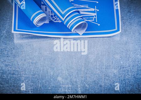 Blue engineering drawings on metallic background construction concept ...
