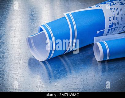 Blue engineering drawings on metallic background construction concept ...