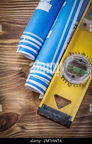Blue rolled construction drawings level on metallic background ...