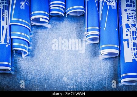 Blue rolled engineering drawings on grey background construction ...