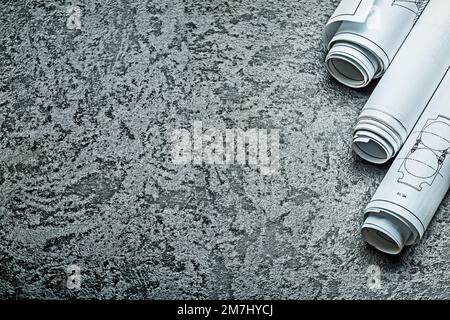 Copyspace view rolled blueprints on black background Stock Photo - Alamy