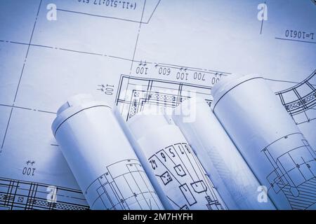 Four rolled up blueprints close up view Stock Photo - Alamy