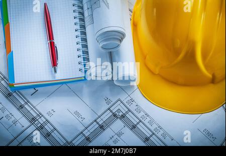Checked notebook pen building helmet Stock Photo - Alamy