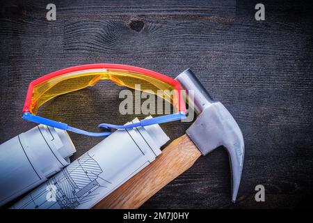 Rolled blueprints hammer goggles on wood board Stock Photo - Alamy