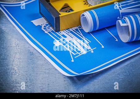 Rolls of construction plans on metallic background building and ...
