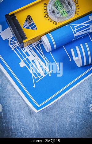 Blue engineering drawings on metallic background construction concept ...