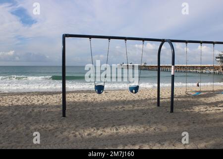 Empty children's swing set on San Clemente State Beach, California ...