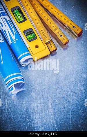 Construction level wooden meter blue rolled blueprints try square on ...