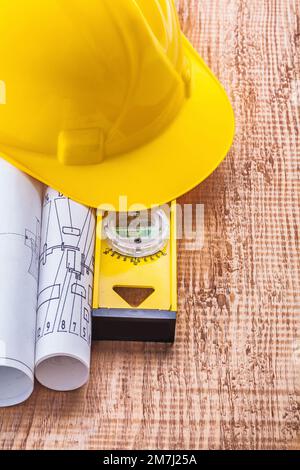 yellow construction level hardhat and blueprints Stock Photo - Alamy