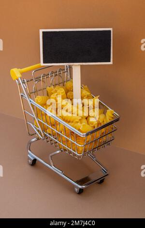INFLATION text on Blackboard label against Shopping trolley cart with ...
