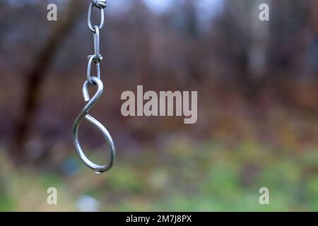 Hanging iron chains against natural background Stock Photo - Alamy