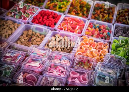 Assortment of colorful sweet handmade candy pieces arranged on yellow ...
