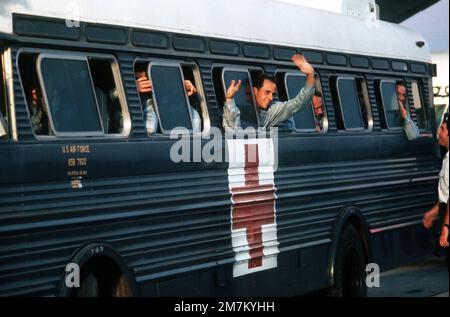 A released prisoner waves from a bus as they leave Insein Prison in ...