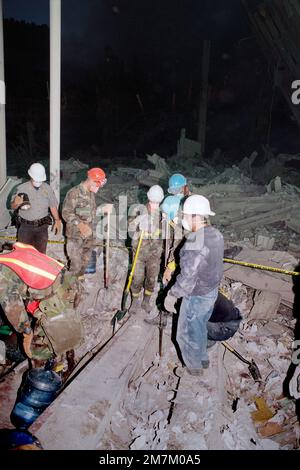 Rescue workers recover the body of a victim who died when the roof ...