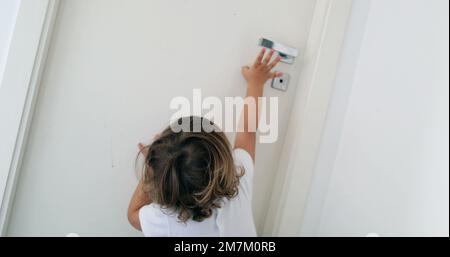 Baby trying to reach door knob. Child on tip toes reaching for door2 ...