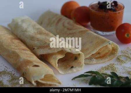 Thin crispy Indian crepe made of brown top millet and lentils. A ...