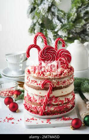 Christmas many layers cake decorated with lolli pops, red and white ...