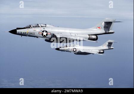 A left side view of the two F-101 Voodoo aircraft landing, with their ...