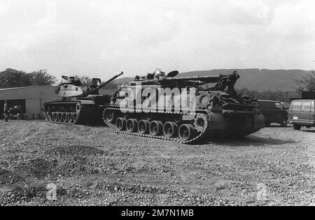 A right side view of an M-88 armored recovery vehicle towing an Armored ...
