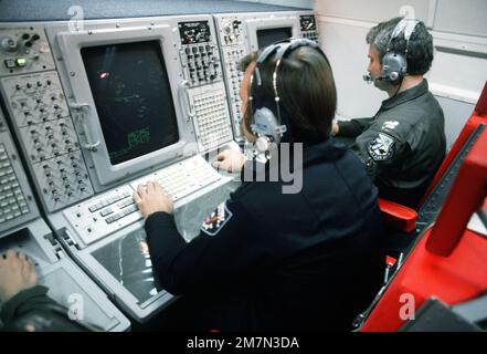 U.S. Air Force officers monitor radar consoles aboard an NKC-135 ...