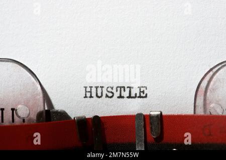 Hustle word written with a typewriter Stock Photo - Alamy