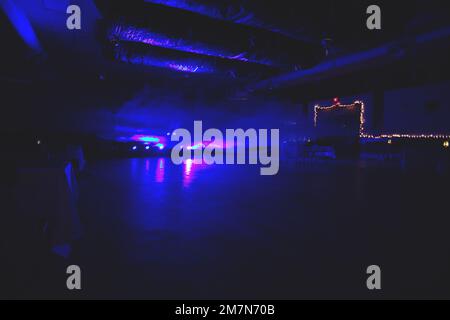 A dark empty venue with decorated tables and lights Stock Photo - Alamy