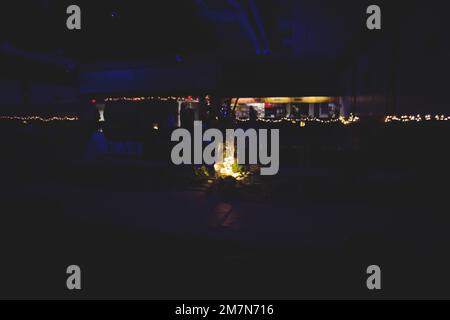 A dark empty venue with decorated tables and lights Stock Photo - Alamy