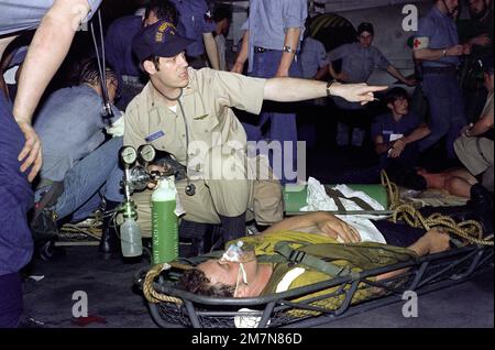 Lieutenant Commander James A. Gessler, senior medical officer, comforts ...