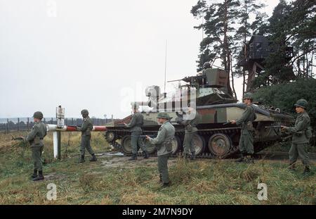 Members of the 11th Armored Cavalry deploy from an M113A1 armored ...