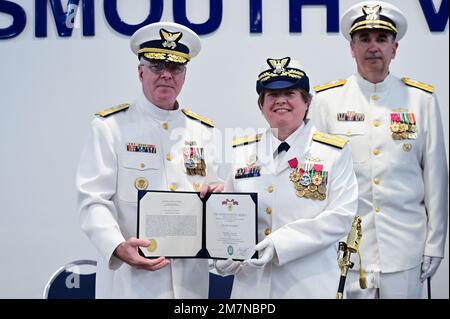 Vice Adm. Steven Poulin presents the unit commendation to Seaman Colin Haggerty, the designated ...