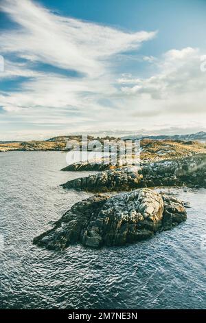 Typical norwegian coastline with rocks at low tide at a fjord in Troms ...