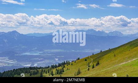 The big mountains of the Gerlitzen Alps in Austria and a lake with the ...