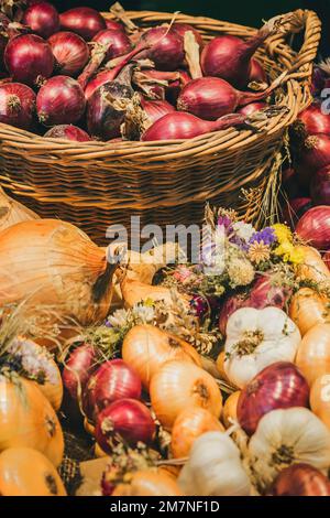 Close up of a basket of onions for sale in the produce aisle of a ...